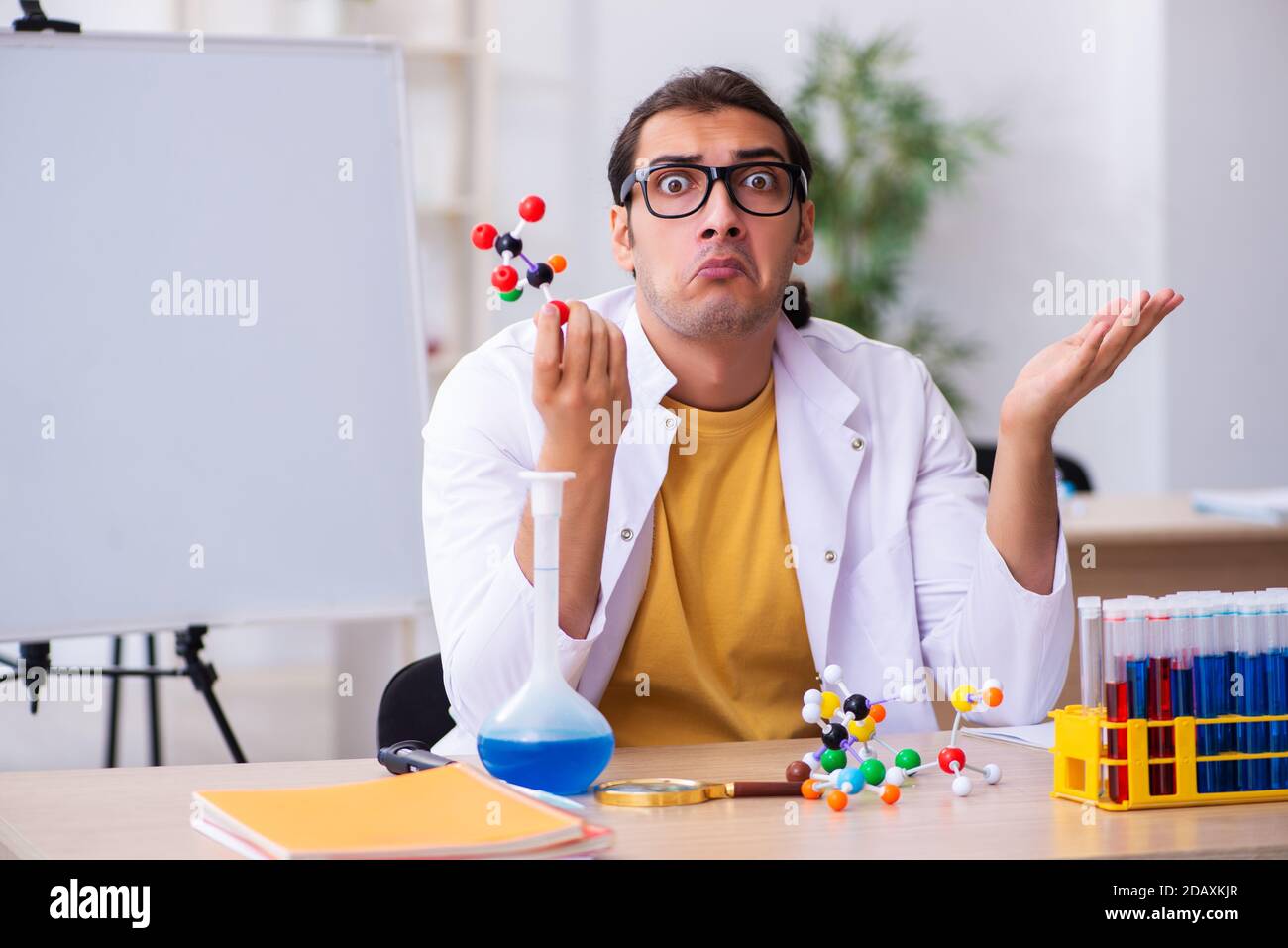 Young chemist studying molecular model in the classroom Stock Photo - Alamy