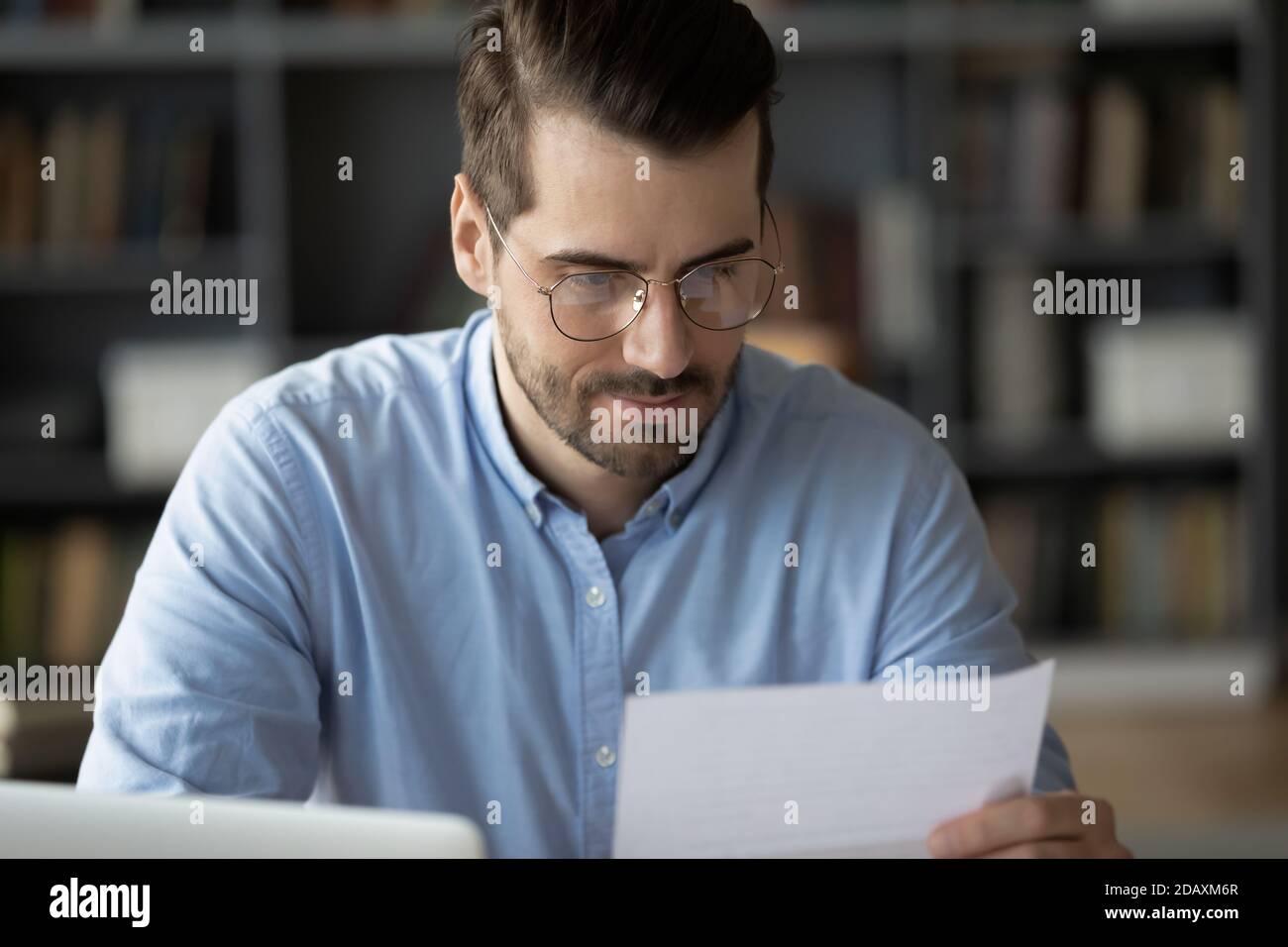 Serious man sitting at workplace reading formal business letter Stock ...