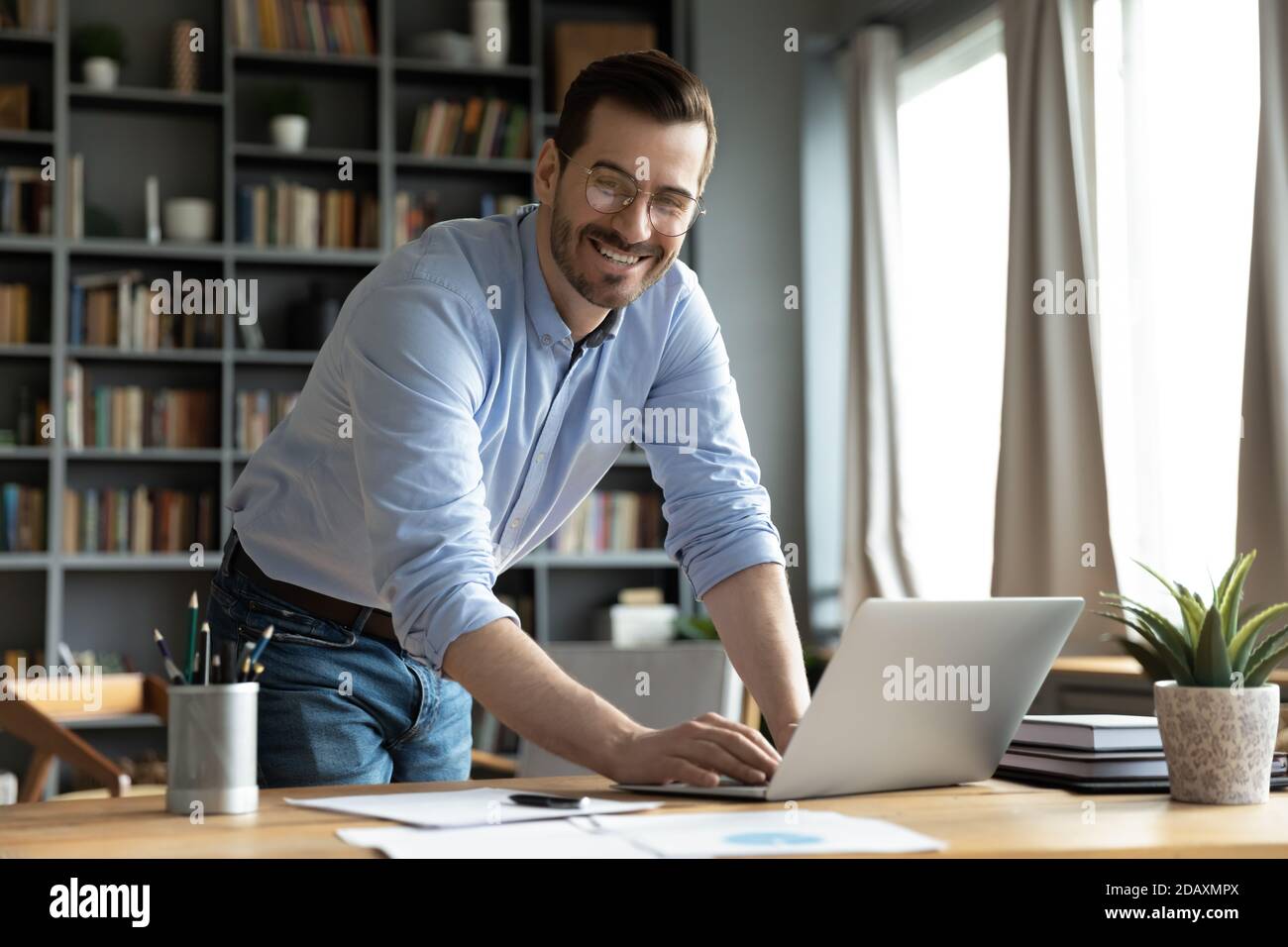 Successful business owner standing in office smile look at camera Stock ...