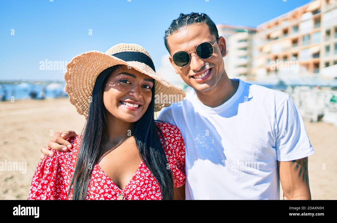 Young latin couple smiling happy and hugging at the beach Stock Photo ...