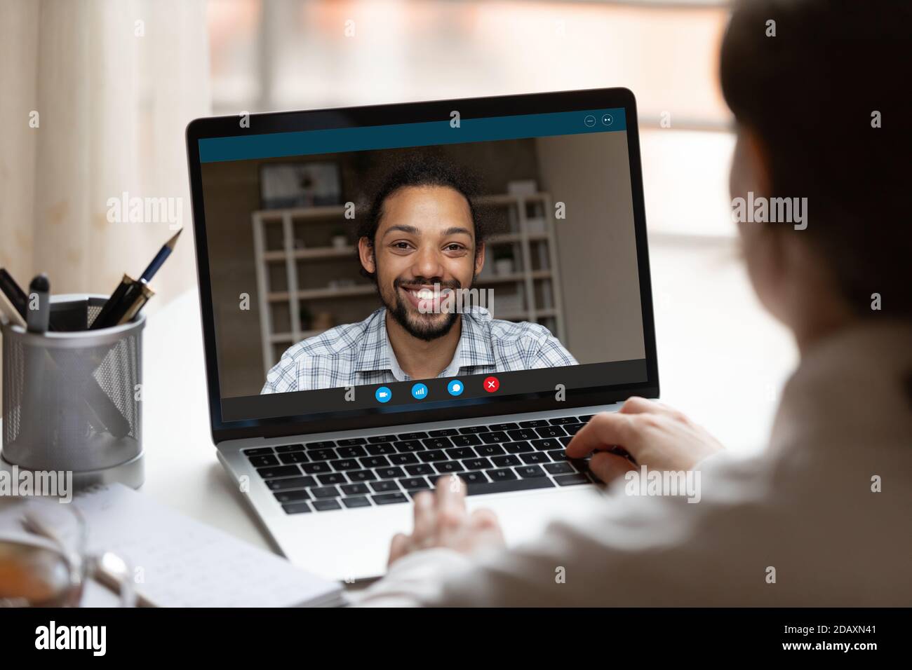 Young woman holding video call conversation with african american ...