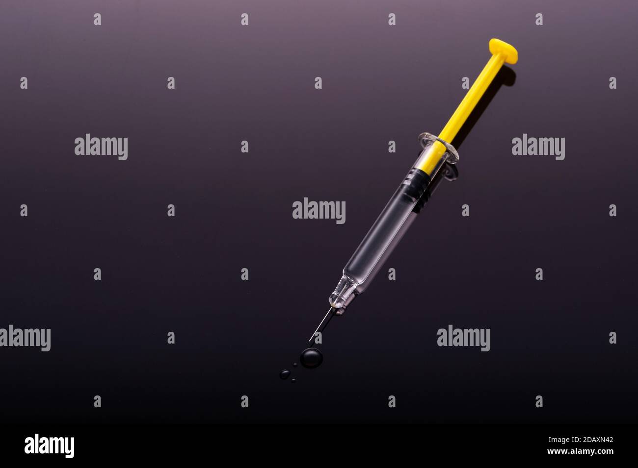 Yellow Syringe on glossy black background. Dark side of Immunization ...