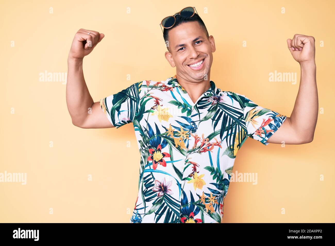 Young handsome latin man wearing summer clothes showing arms muscles ... Young handsome latin man wearing summer clothes showing arms muscles ...