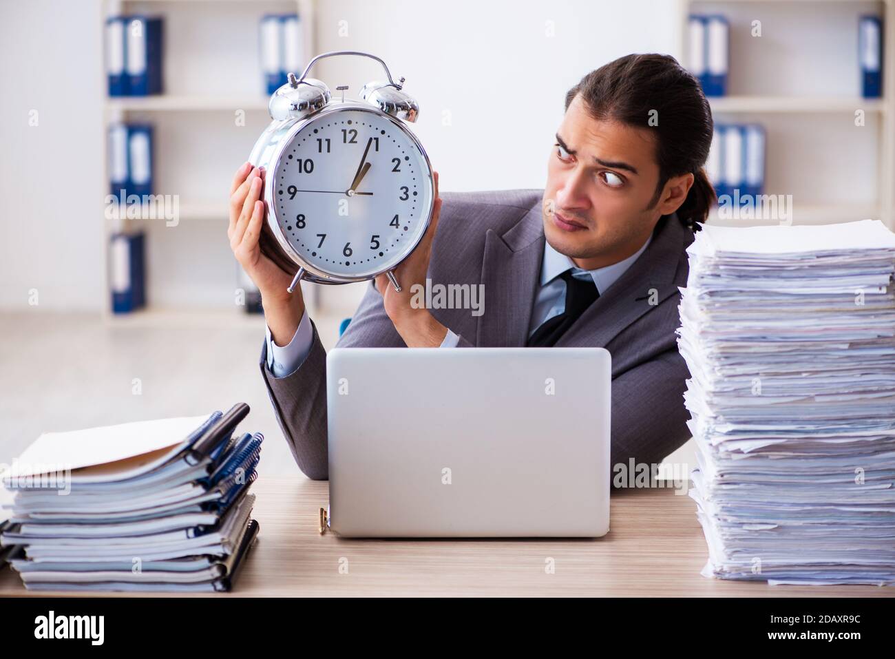 Workload employee in time management concept Stock Photo - Alamy
