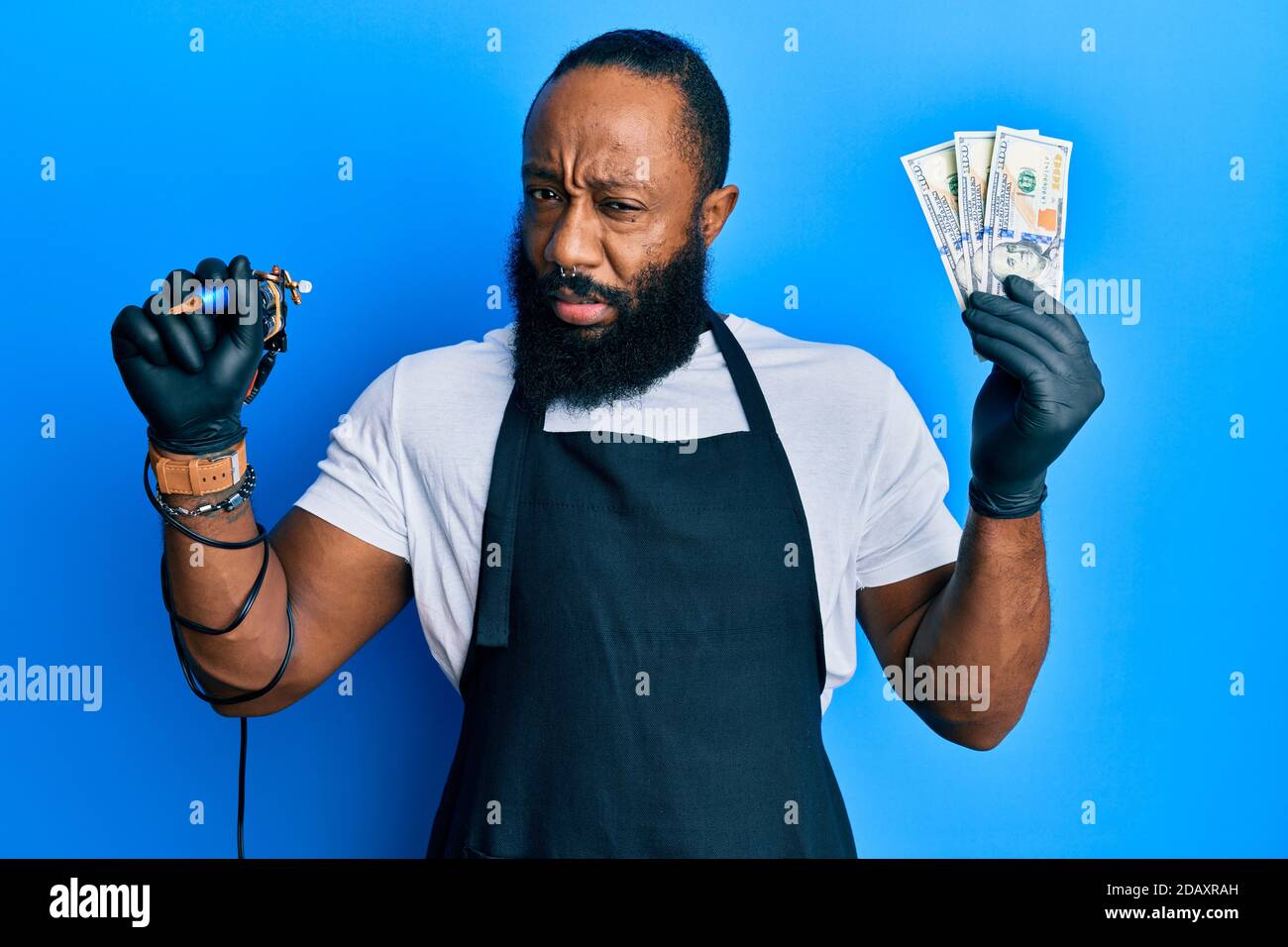 Young african american man tattoo artist wearing professional uniform ...