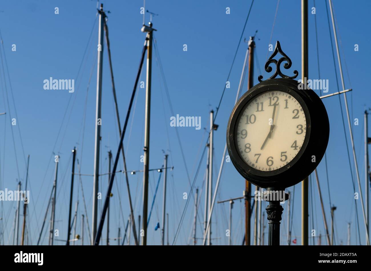 clock at dutch harbour with masts and blue sky in background Stock ...