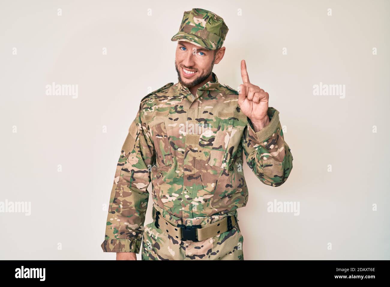 Young caucasian man wearing camouflage army uniform showing and ...