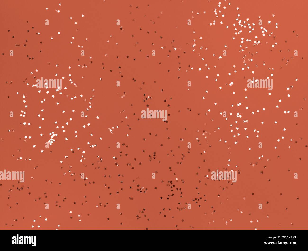 Confetti stars sparkling on a orange background Stock Photo - Alamy