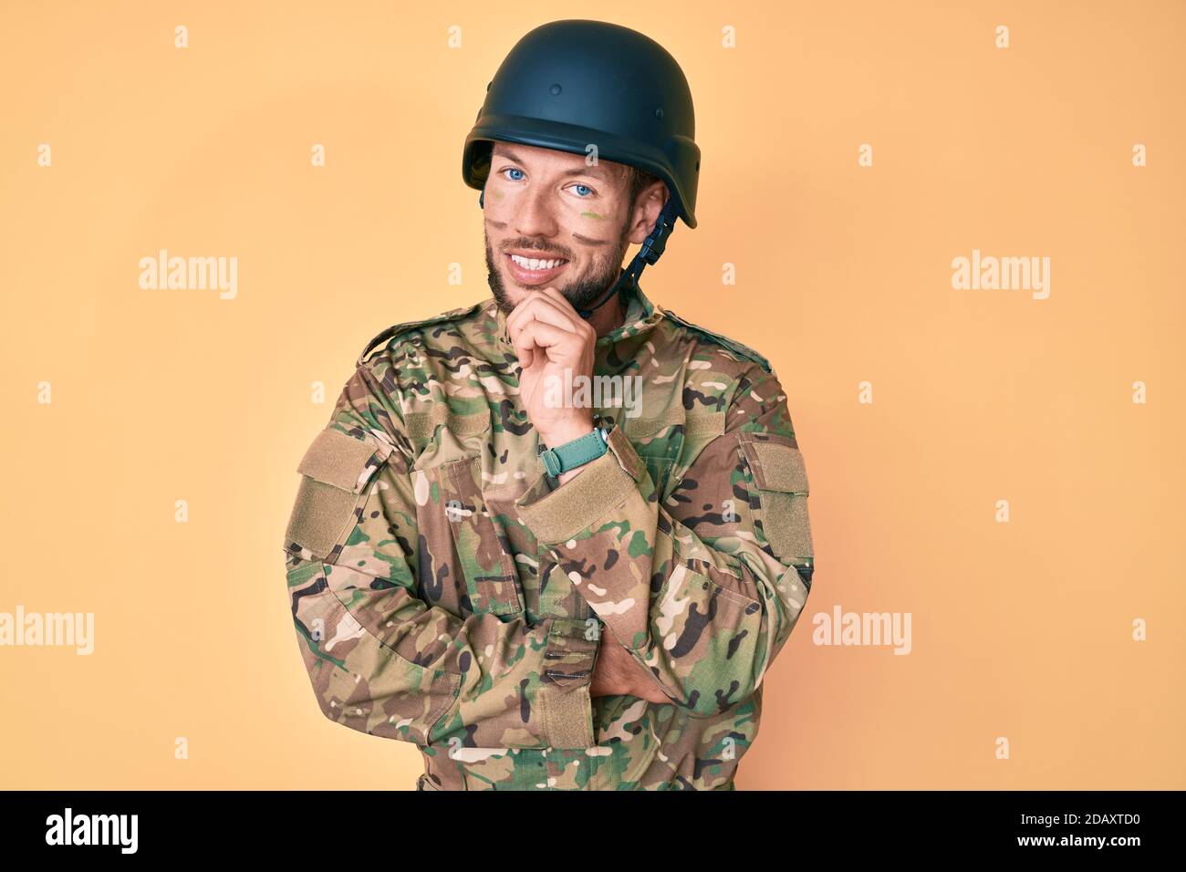 Young caucasian man wearing camouflage army uniform smiling looking ...