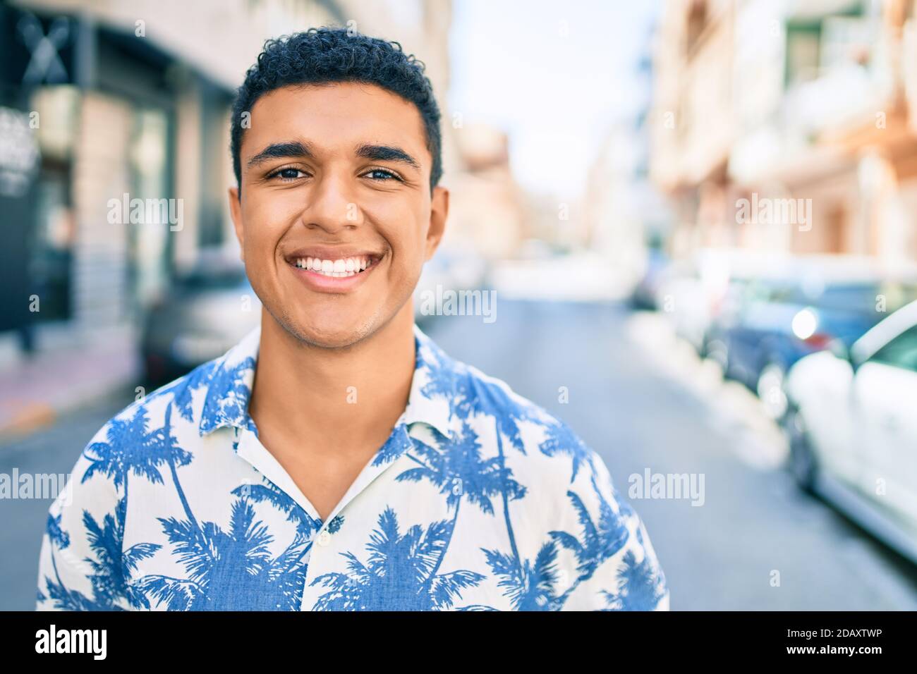 Young arab tourist man wearing summer style walking at street of city ...