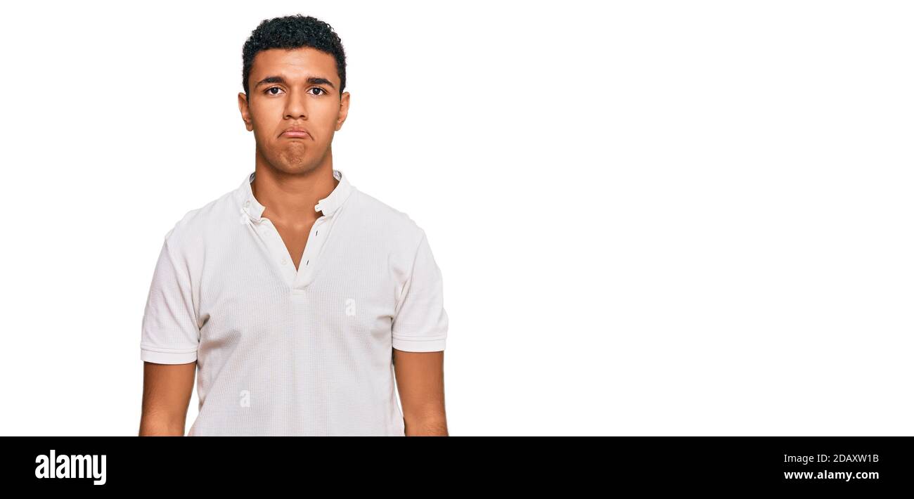 Young arab man wearing casual clothes depressed and worry for distress ...