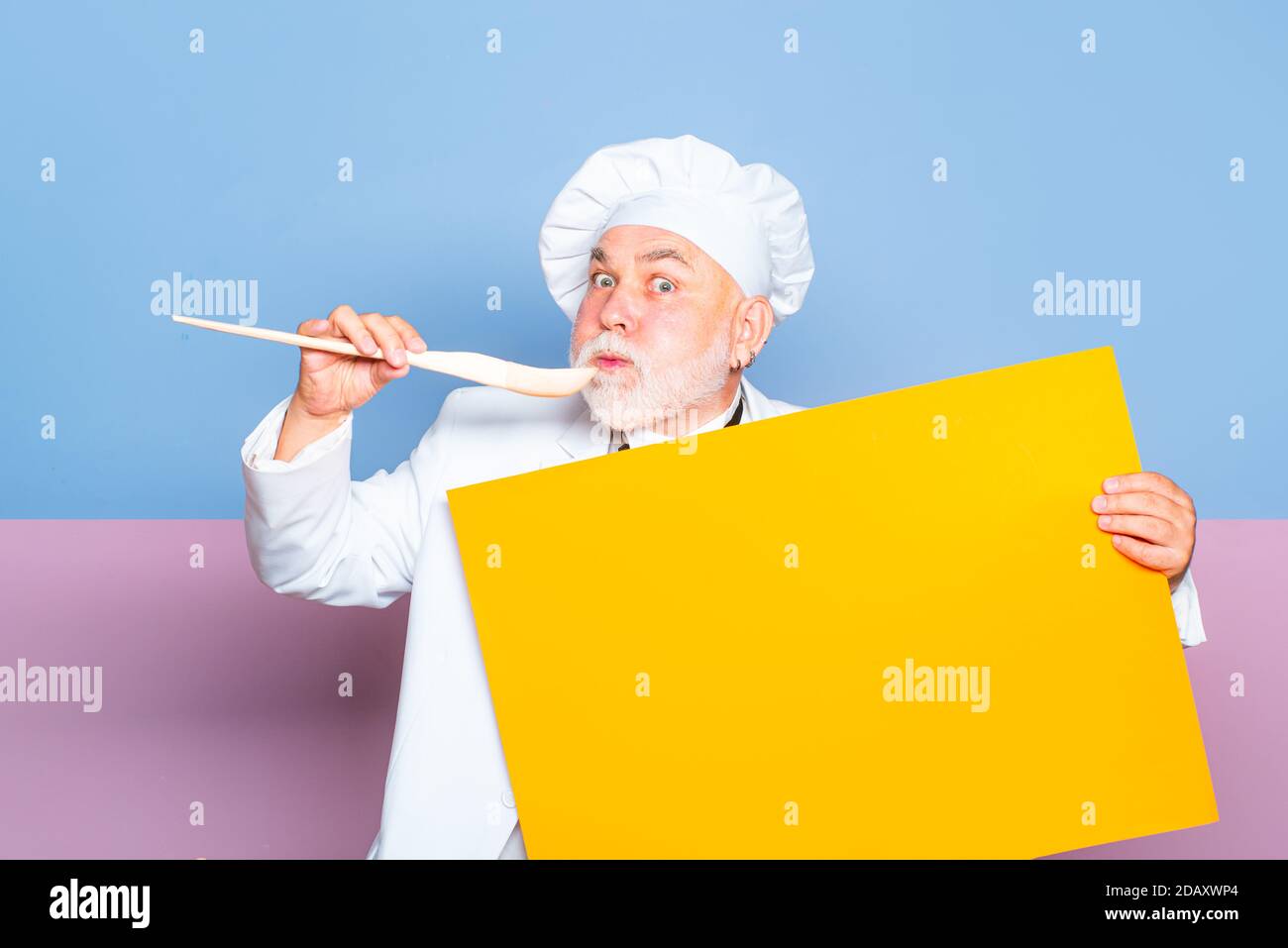 Senior Chief cook, blackboard menu, copy space. Senior male chief cook ...