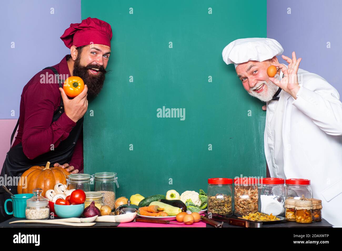 Chief cook. Blackboard menu, copy space. Looking out of cardboard sheet ...
