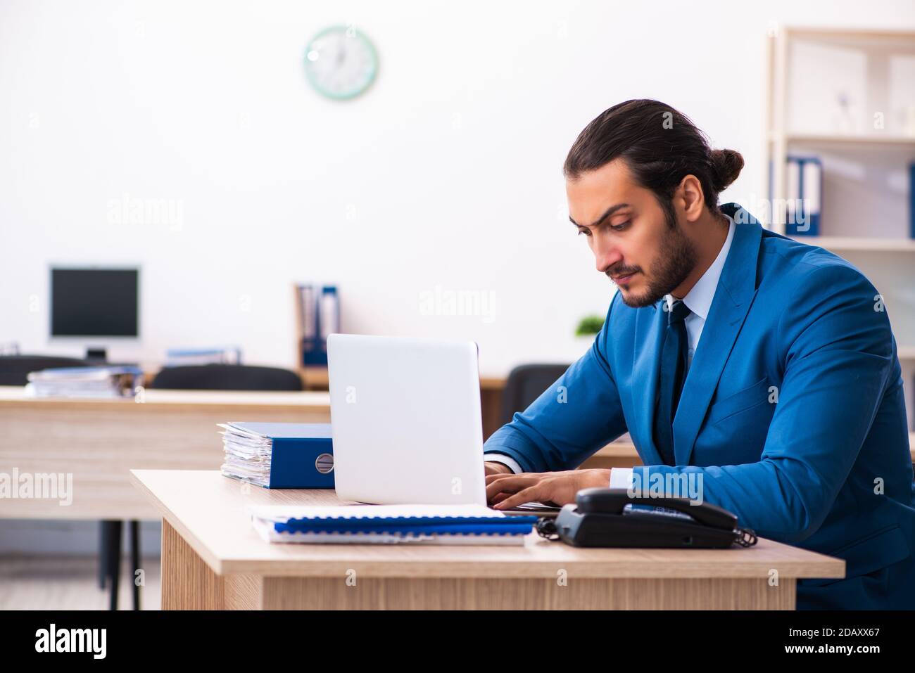 Young employee and too many work in the office Stock Photo - Alamy