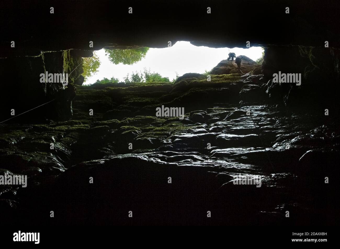 Cavers nearing the top of the rope climb in the gaping chasm of Eldon ...