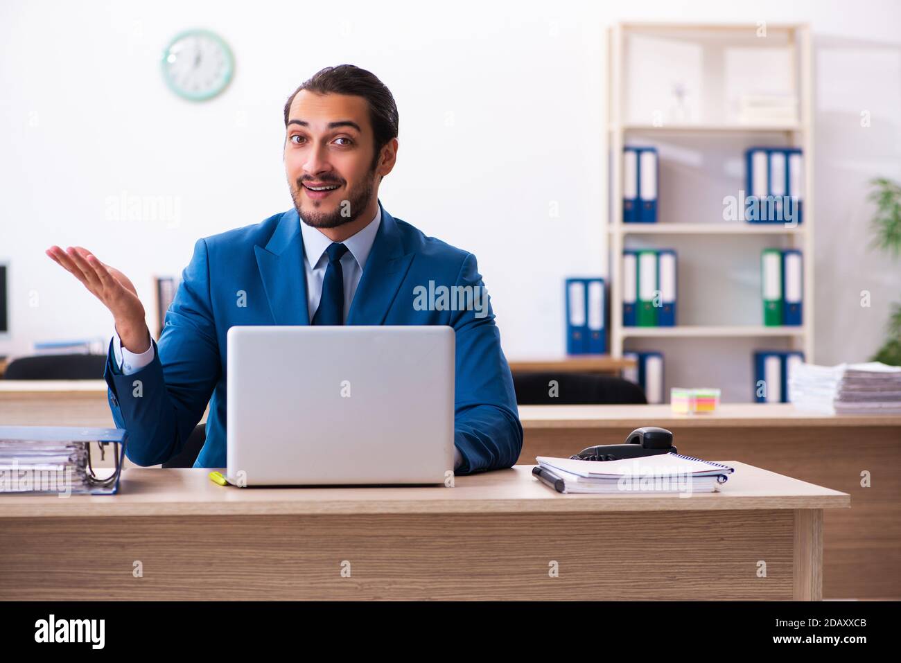 Young employee and too many work in the office Stock Photo - Alamy