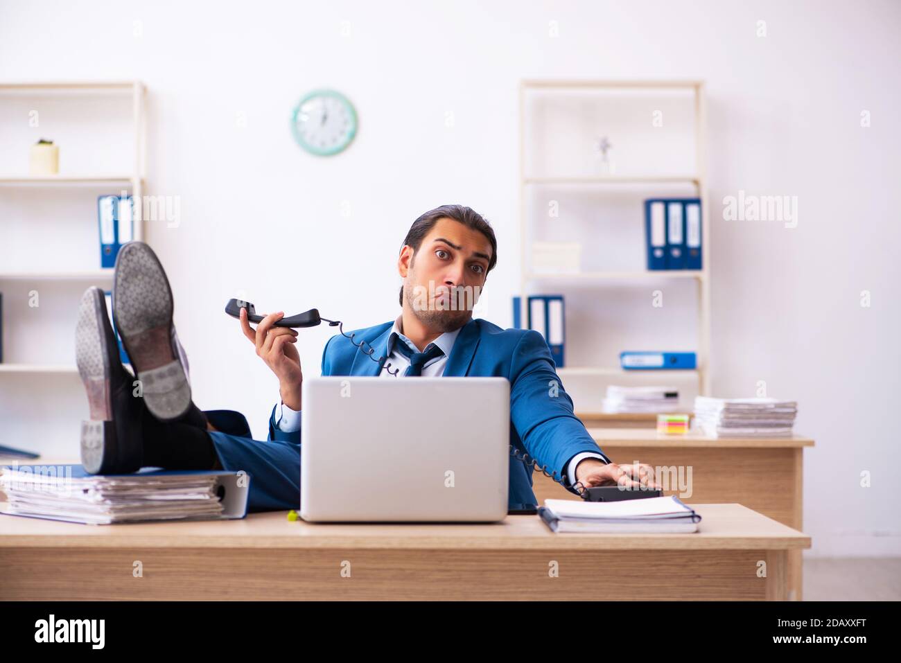 Young employee and too many work in the office Stock Photo - Alamy