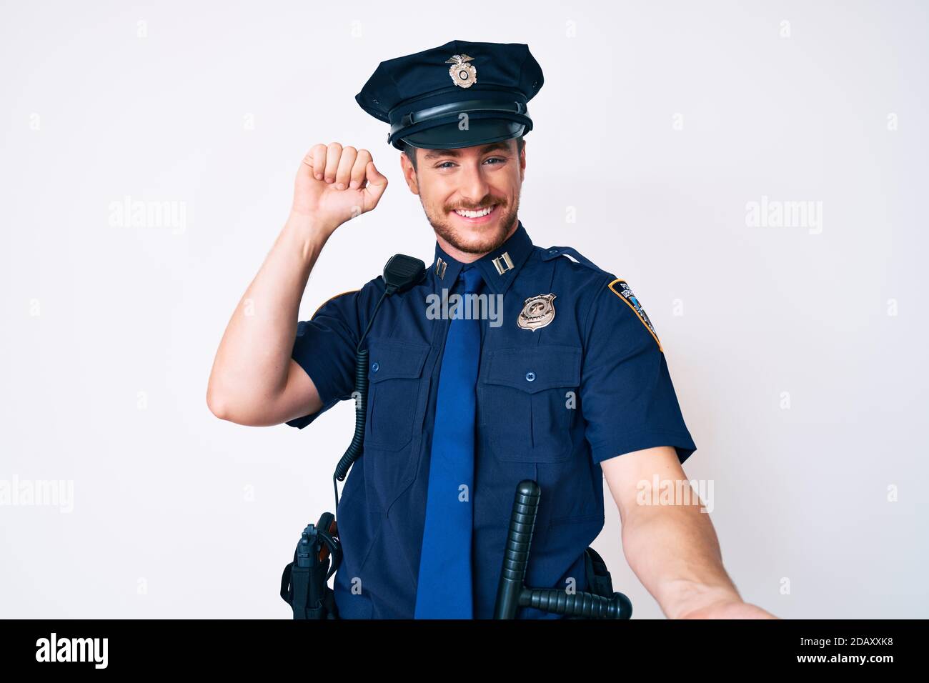 Young caucasian man wearing police uniform dancing happy and cheerful ...