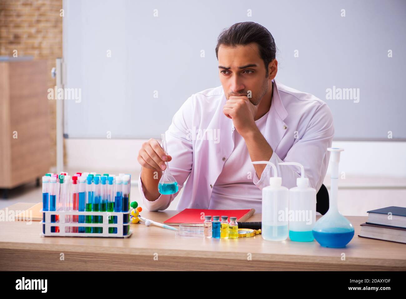 Young chemistry teacher in the classroom Stock Photo - Alamy