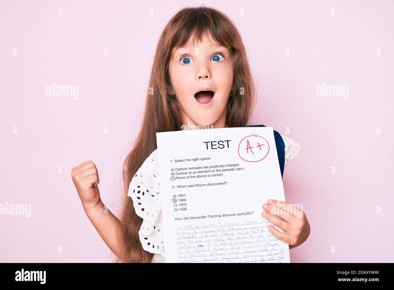 Little caucasian kid girl with long hair showing a passed exam from ...