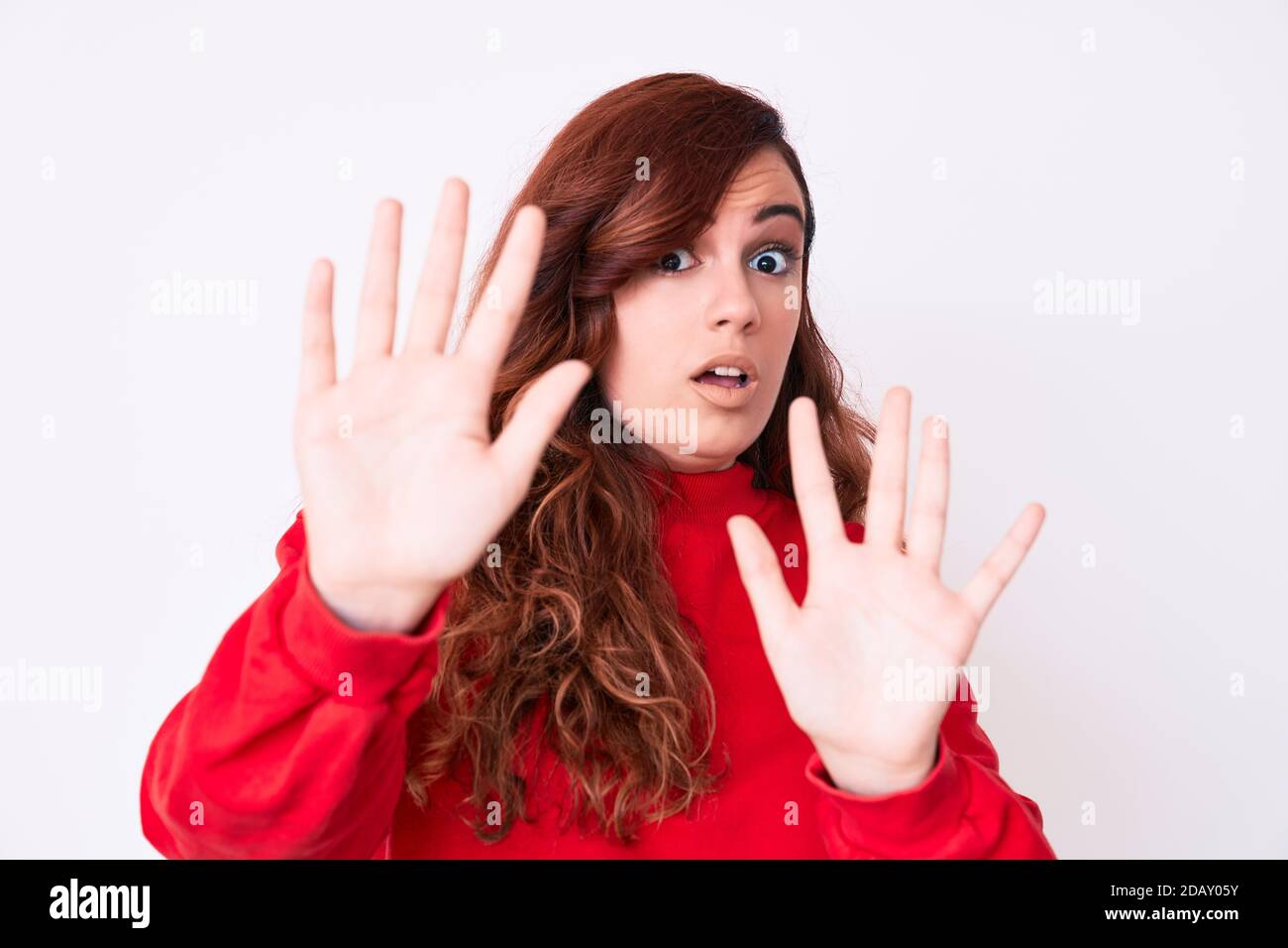 Young beautiful woman wearing casual clothes afraid and terrified with ...