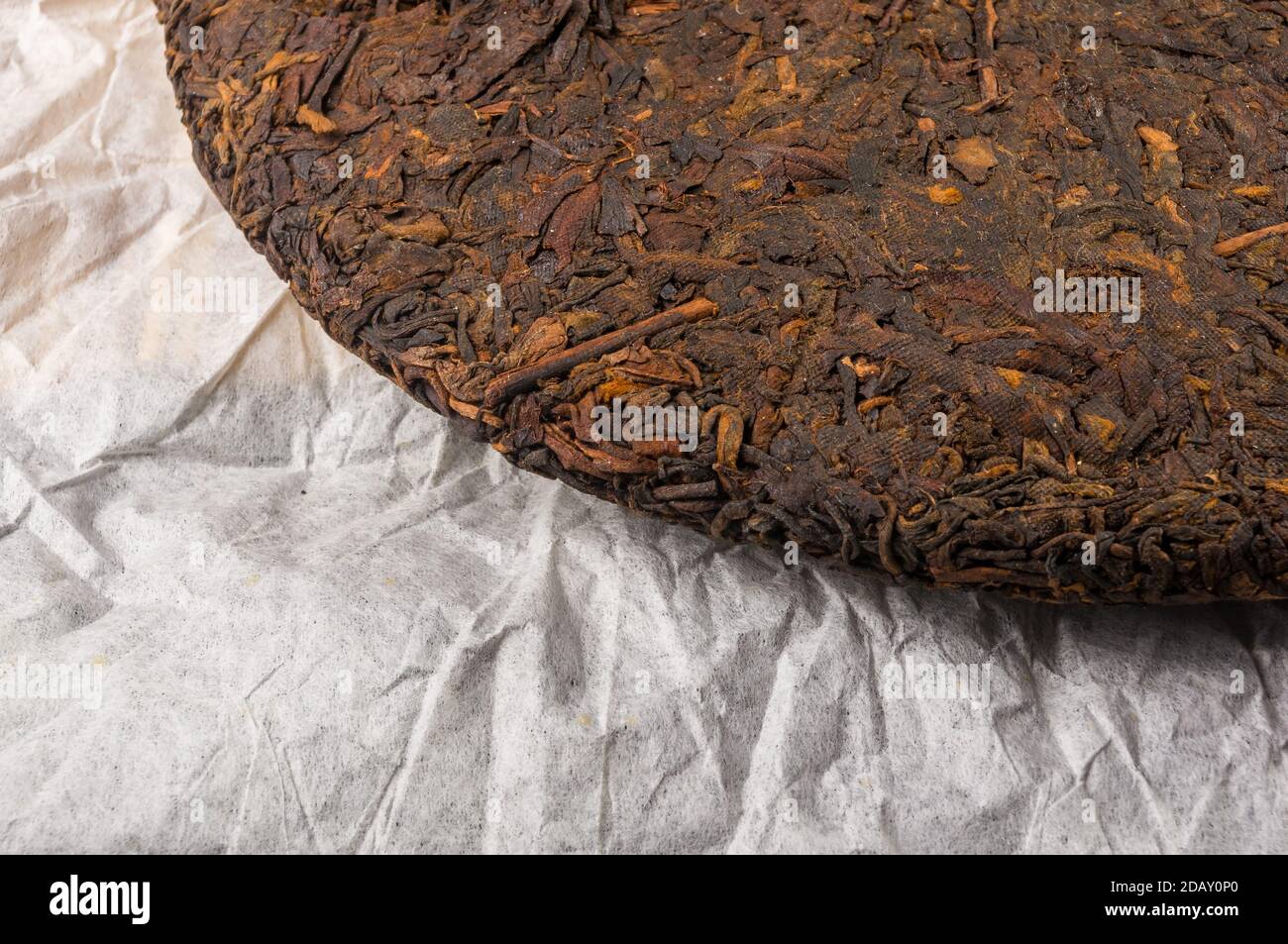 Chinese pressed PU-erh tea on wrapping paper, close-up Stock Photo - Alamy