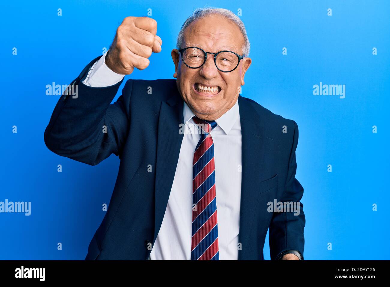 Senior caucasian man wearing business suit and tie angry and mad ...