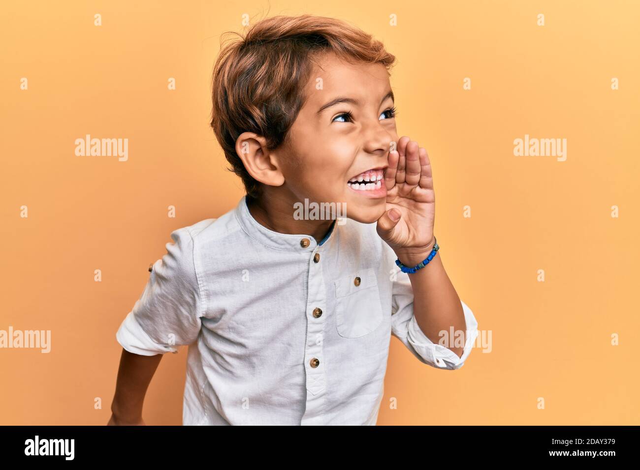 Adorable latin kid wearing casual clothes shouting and screaming loud ...