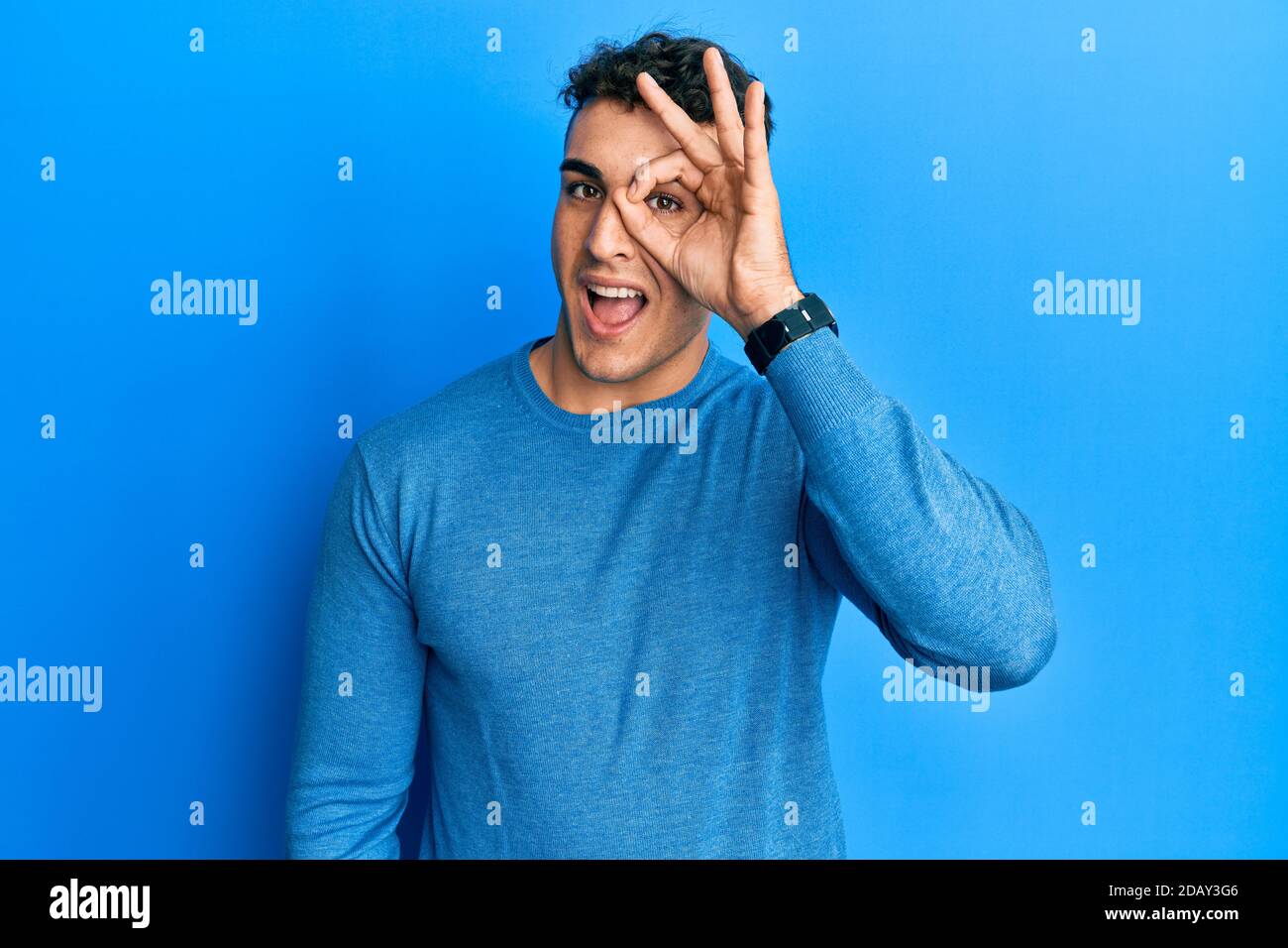 Handsome young man wearing casual clothes looking fascinated with ...
