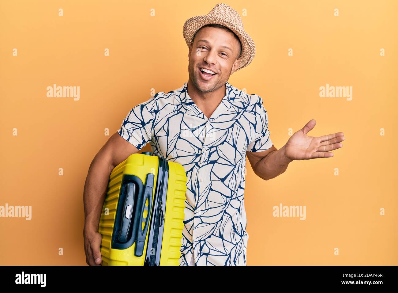 Handsome muscle man holding suitcase going on summer vacation ...