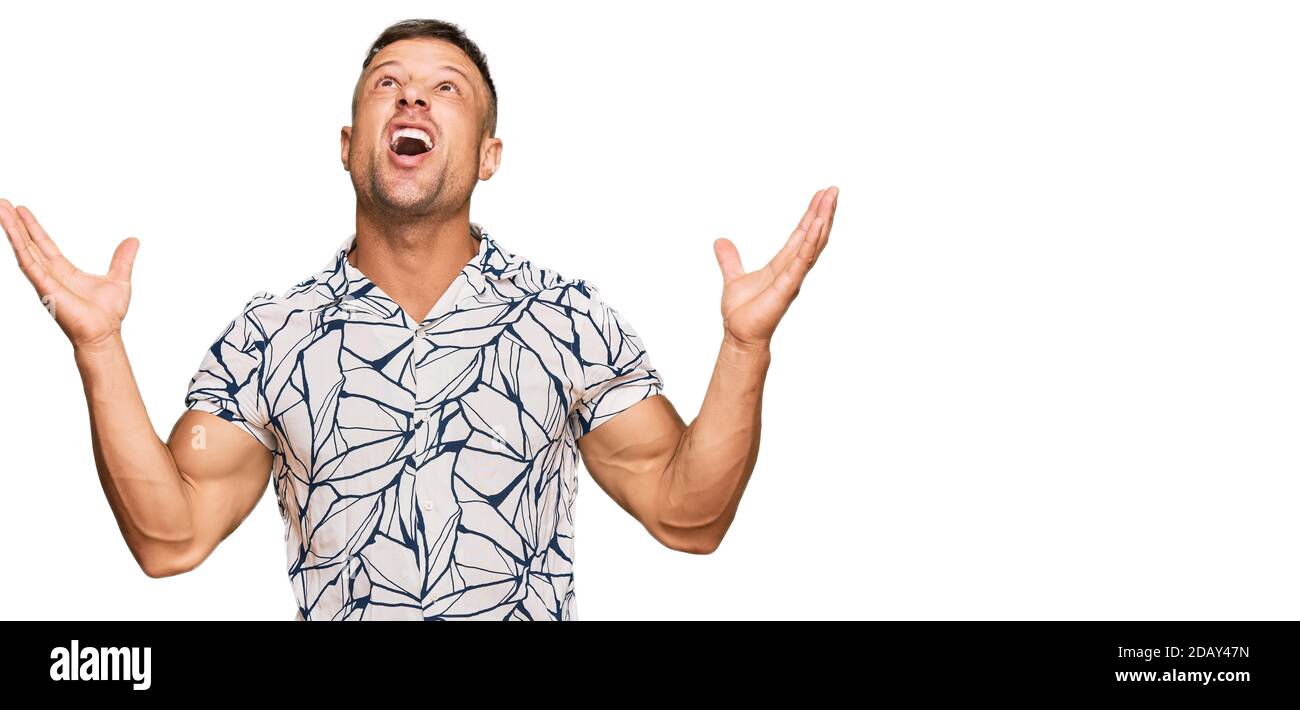Handsome muscle man wearing casual clothes crazy and mad shouting and ...