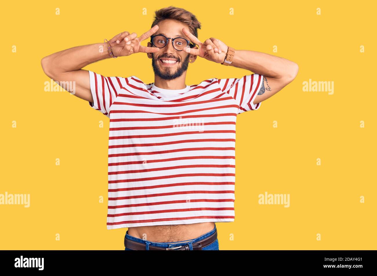 Handsome blond man with beard wearing casual clothes and glasses doing ...