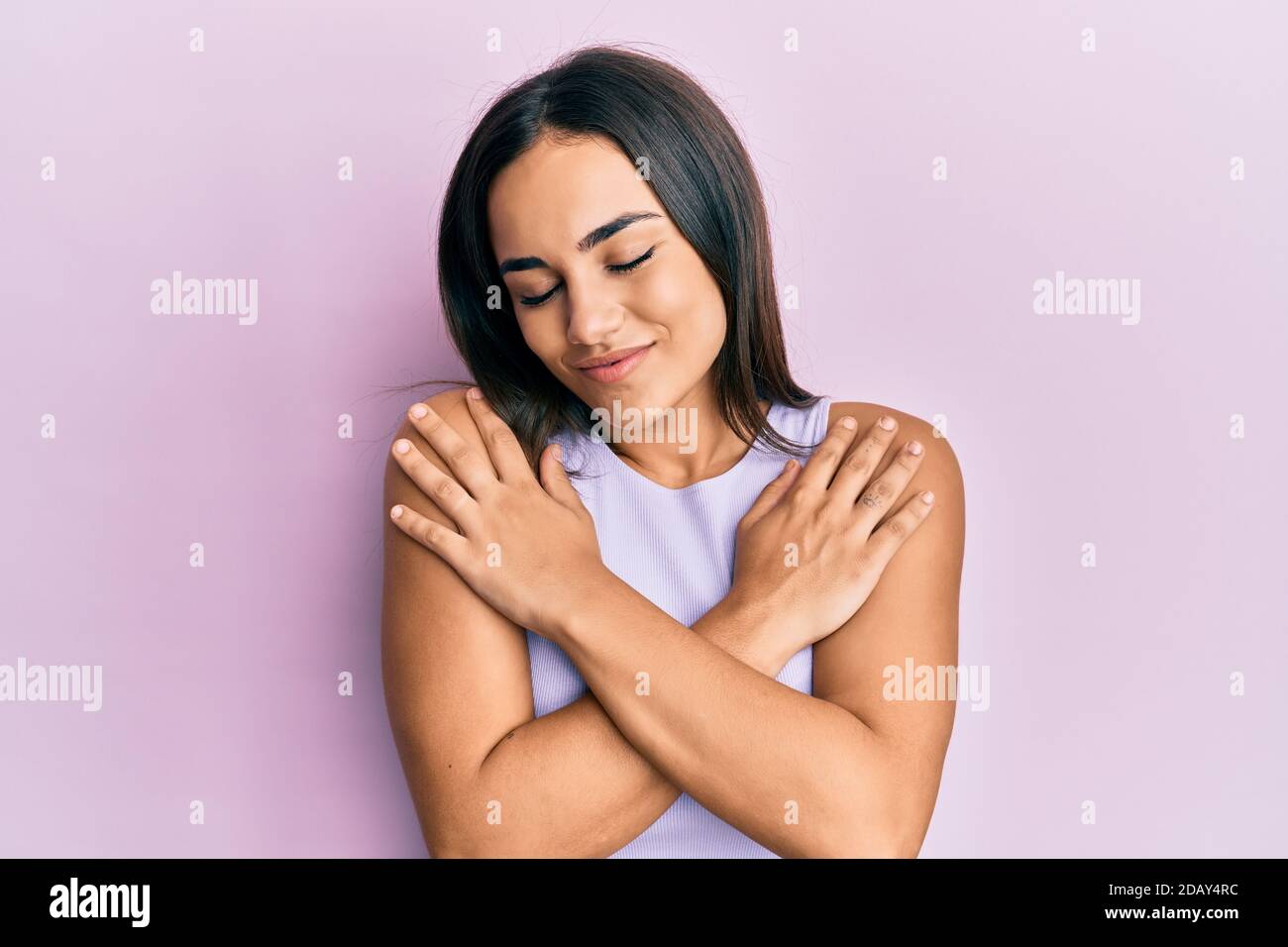 Young brunette woman wearing casual clothes hugging oneself happy and ...