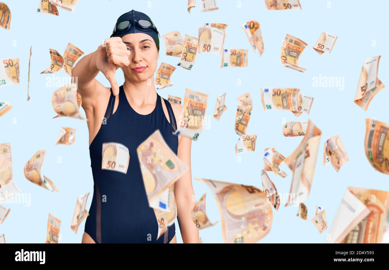 Young beautiful hispanic woman wearing swimwear and swimmer glasses ...