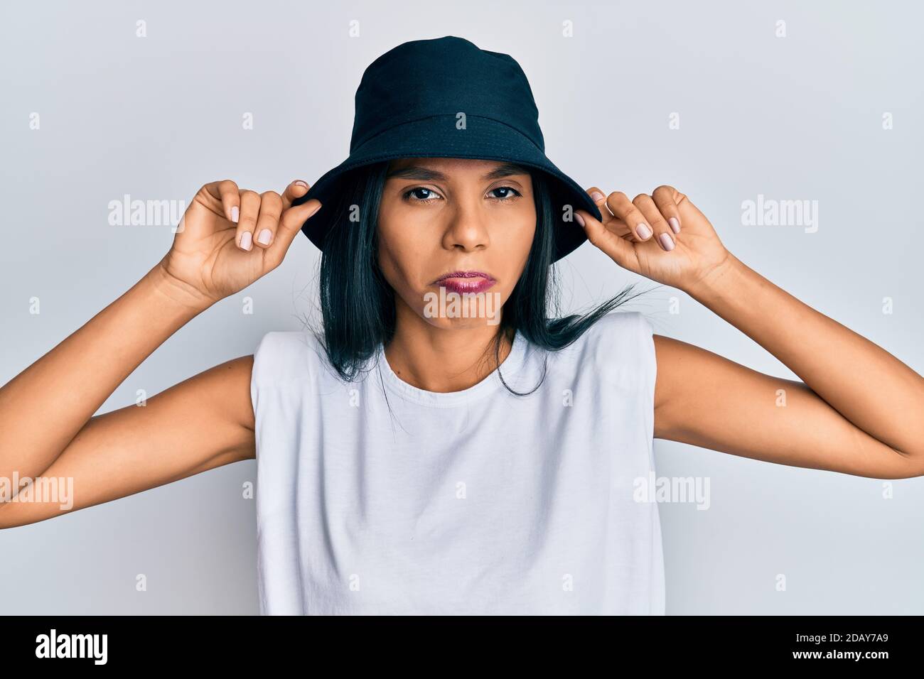Young african american woman wearing fashion hat depressed and worry ...