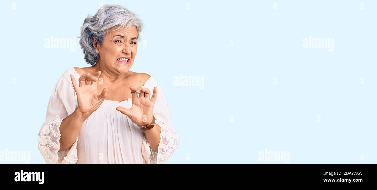 Senior woman with gray hair wearing bohemian style disgusted expression ...