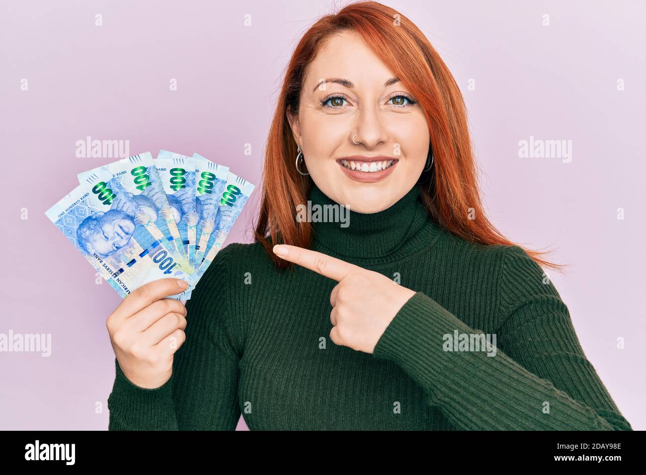 Beautiful redhead woman holding south african 100 rand banknotes ...