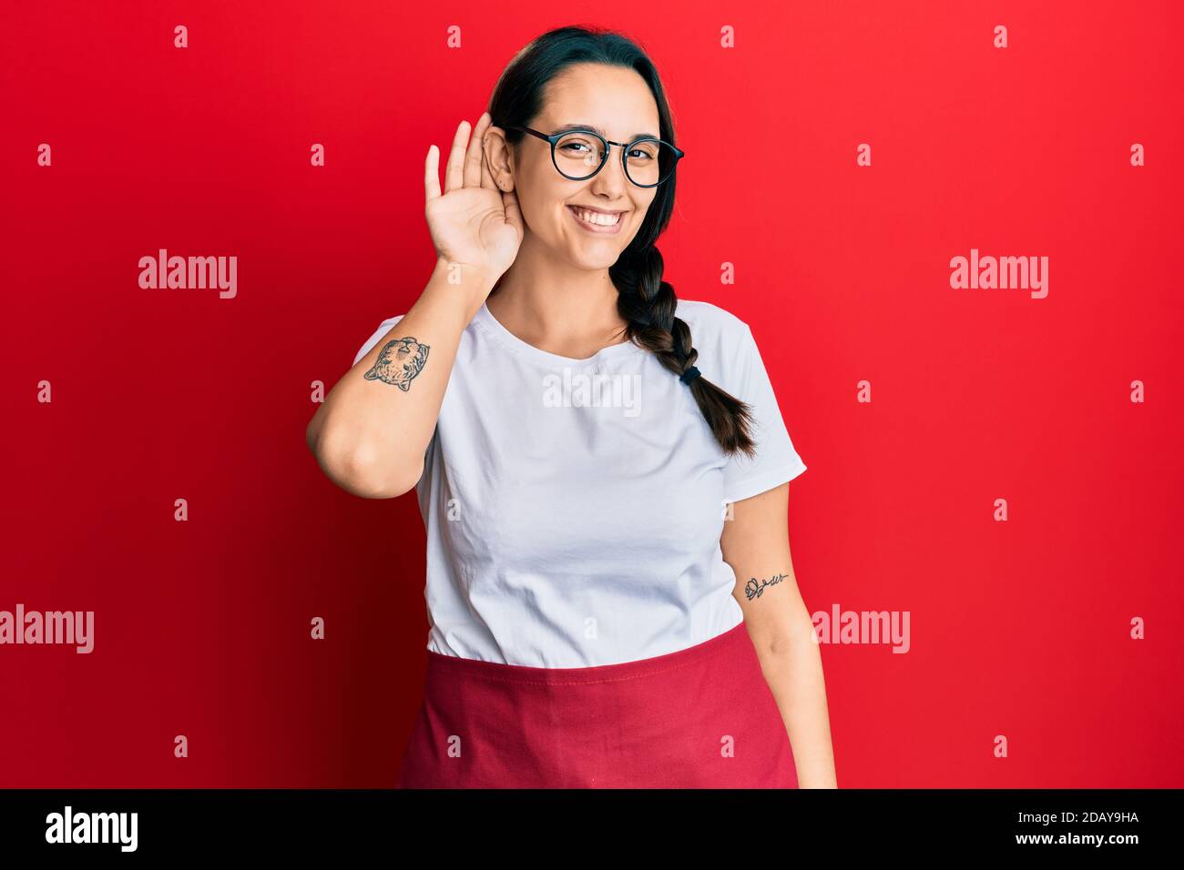 Young hispanic woman wearing professional waitress apron feeling unwell ...