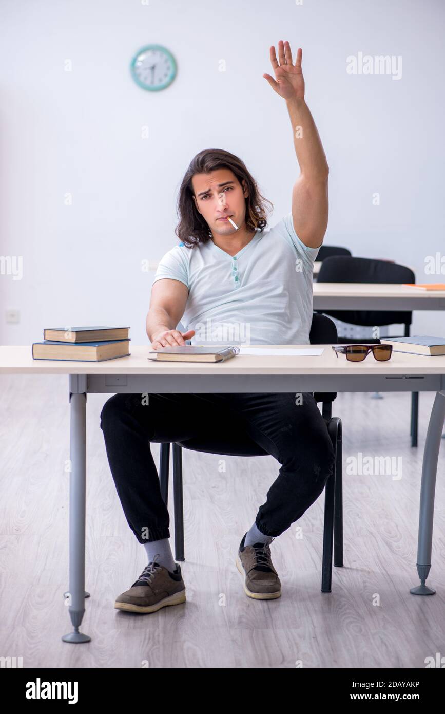 Male student smoking cigarettes in the classroom Stock Photo - Alamy
