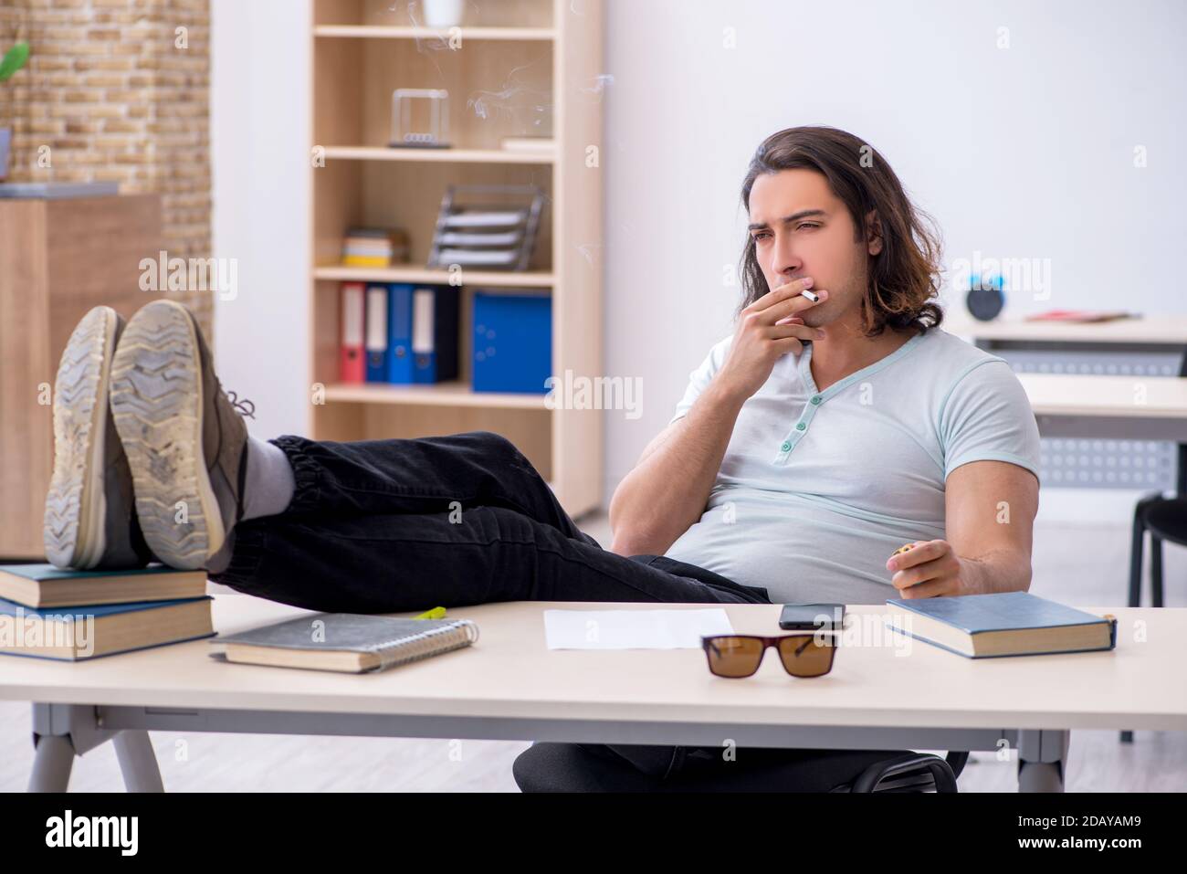 Male student smoking cigarettes in the classroom Stock Photo - Alamy