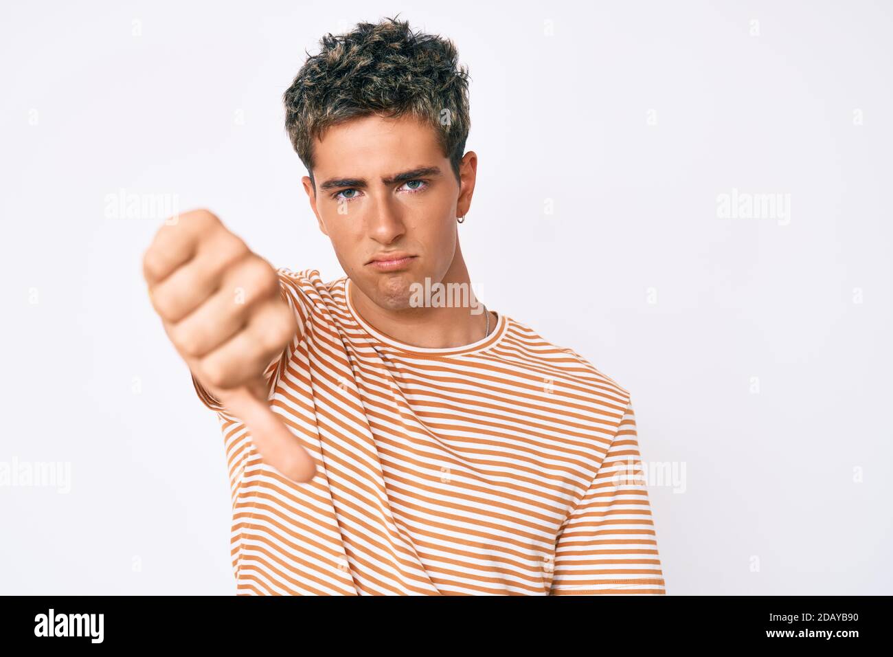 Young handsome man wearing casual clothes looking unhappy and angry ...