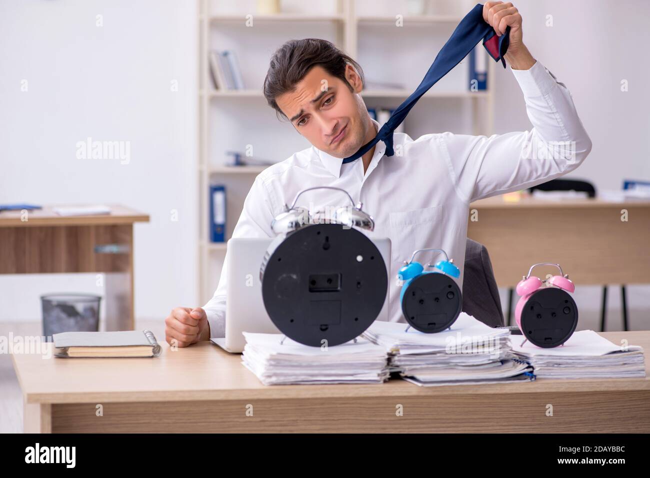 Young employee afraid of missing deadline at workplace Stock Photo - Alamy