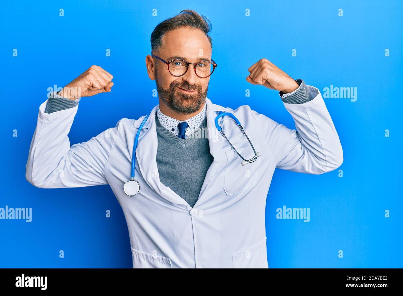 Handsome middle age man wearing doctor uniform and stethoscope showing ...