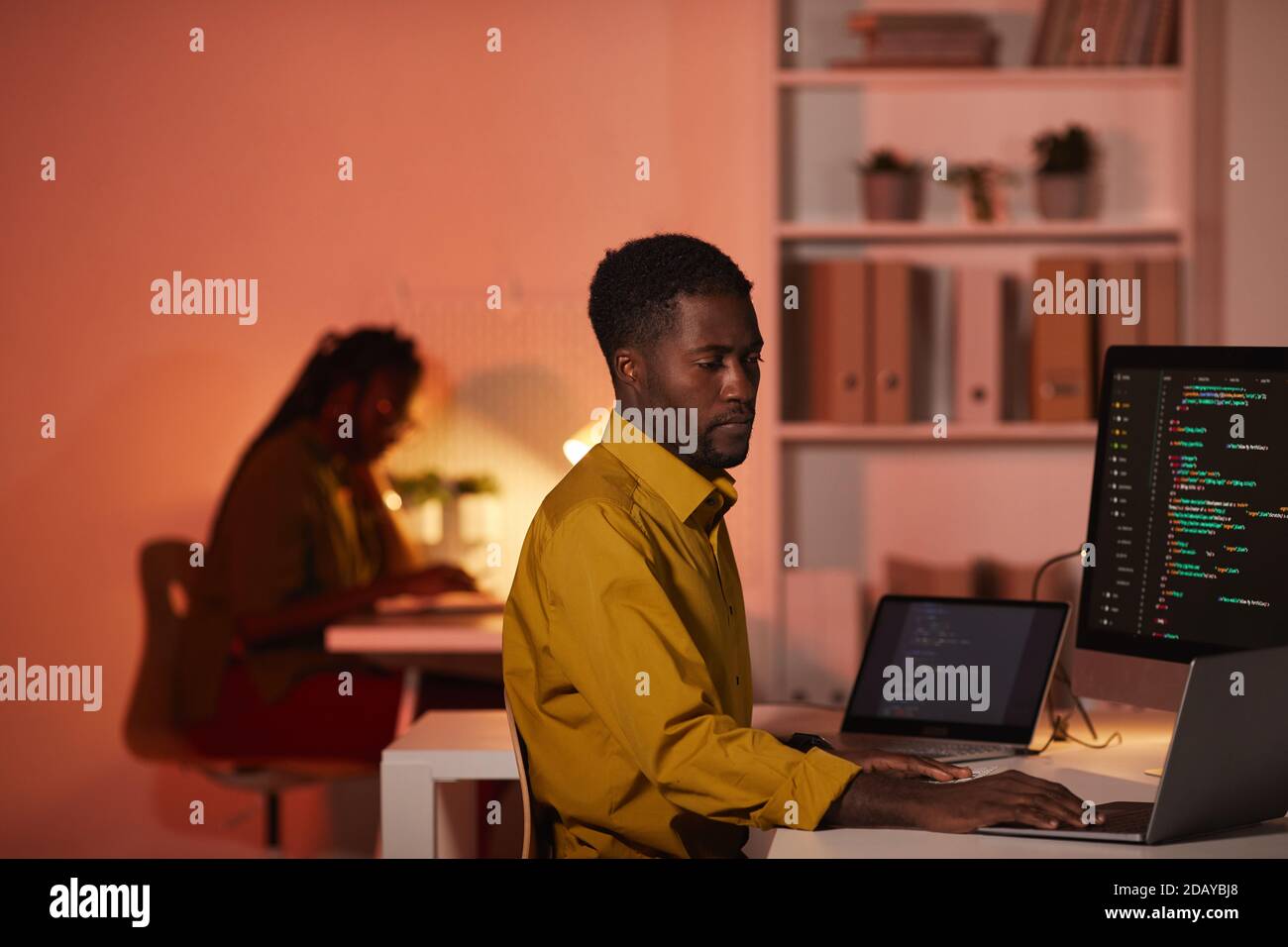 Portrait Of African American It Developer Writing Code On Multiple