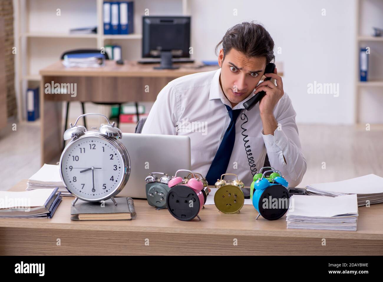 Young employee afraid of missing deadline at workplace Stock Photo - Alamy