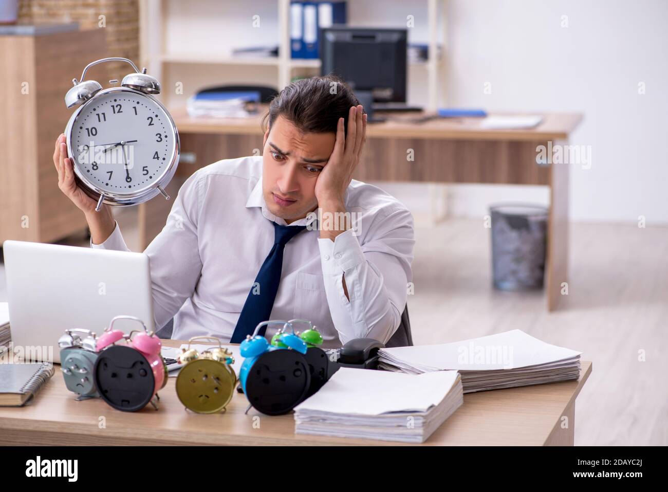 Young employee afraid of missing deadline at workplace Stock Photo - Alamy