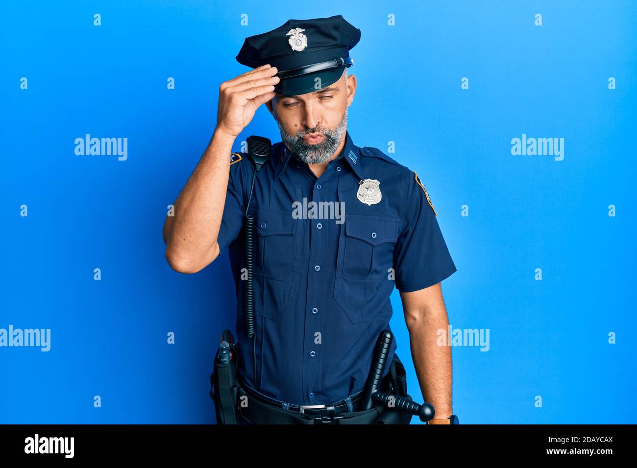 Middle age handsome man wearing police uniform worried and stressed ...