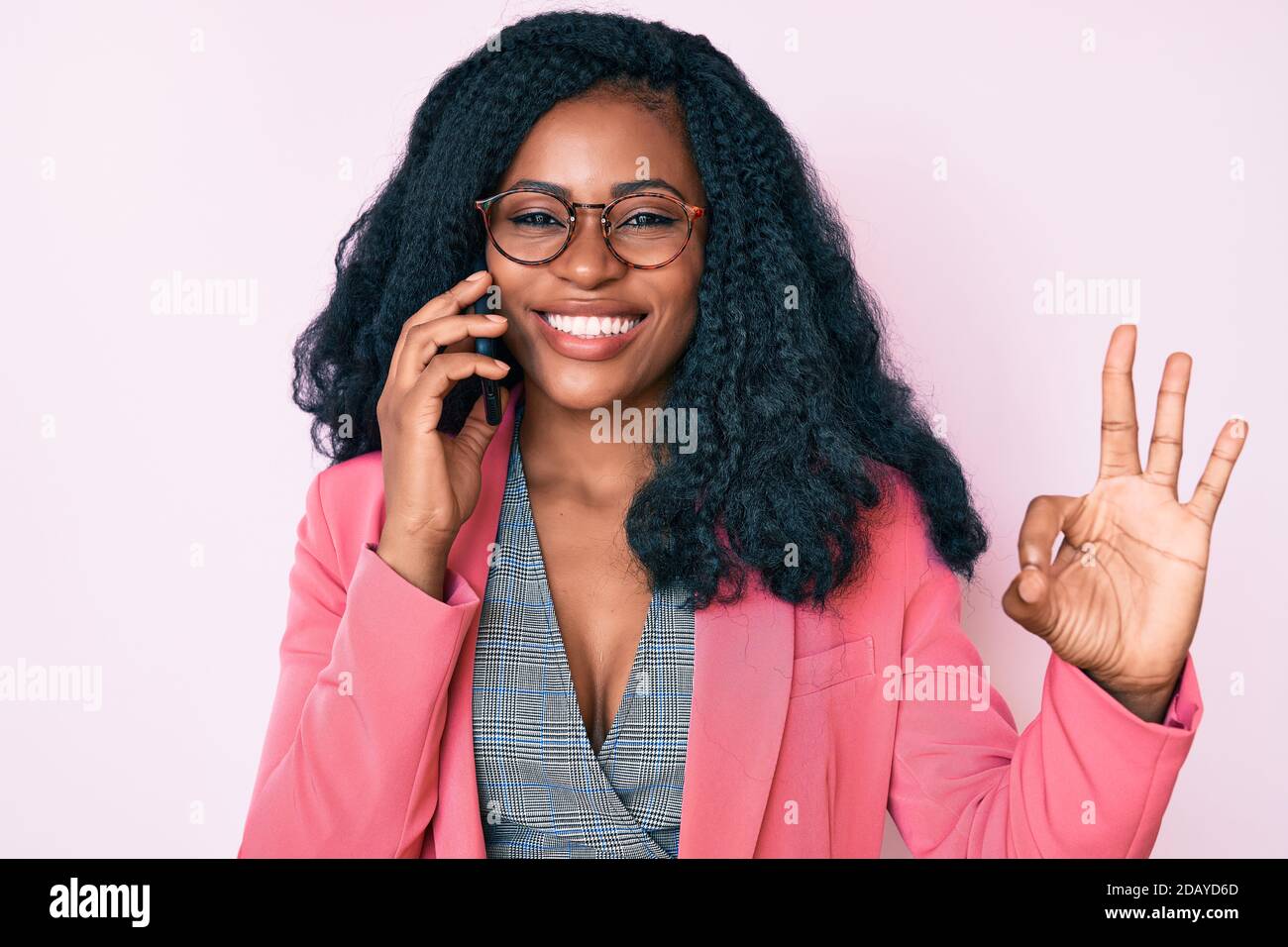 Beautiful african woman having conversation talking on the smartphone ...