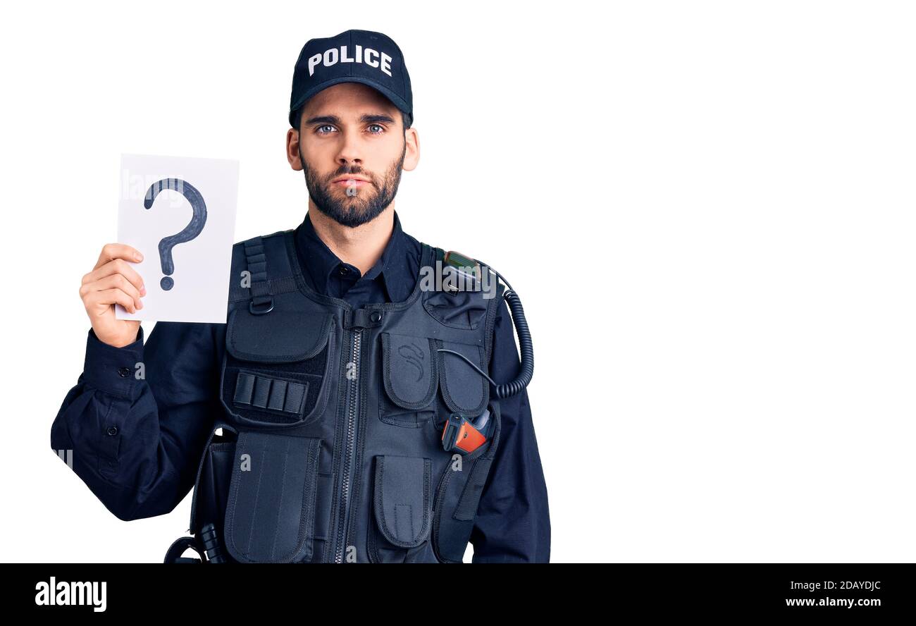 Young handsome man with beard wearing police uniform holding question ...