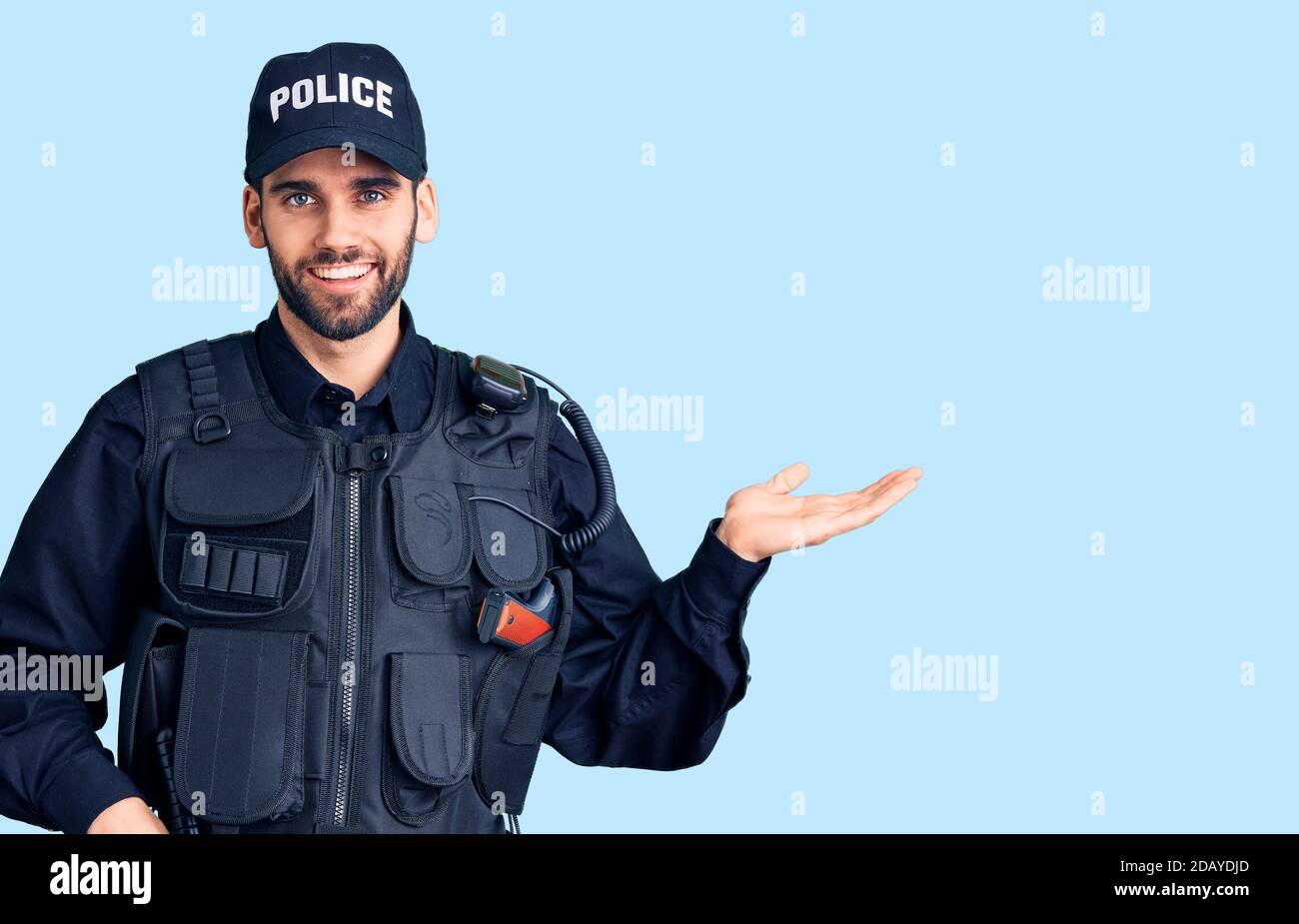 Young handsome man with beard wearing police uniform smiling cheerful ...